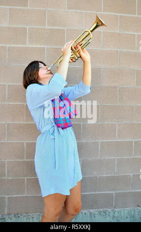 Woman blowing trumpet with folk music group Stock Photo - Alamy