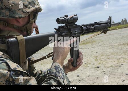 A U.S. Marine checks his M16A4 service rifle for brass during a Stock ...