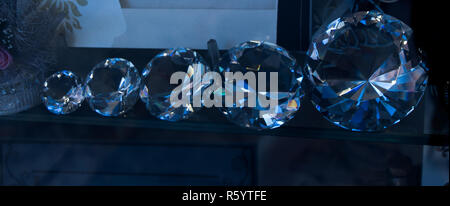 Five transparent diamonds aligned from small to big on display Stock ...