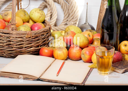 basket of apples, bottles of cider and old notebook Stock Photo - Alamy