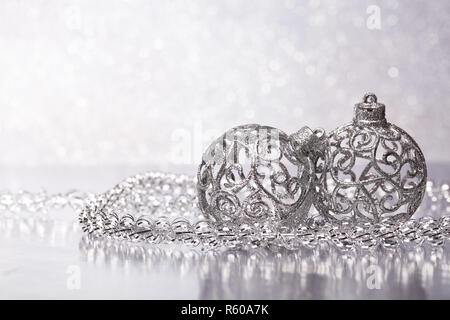 Silvery New Year's ball and decorative snowflake Stock Photo - Alamy