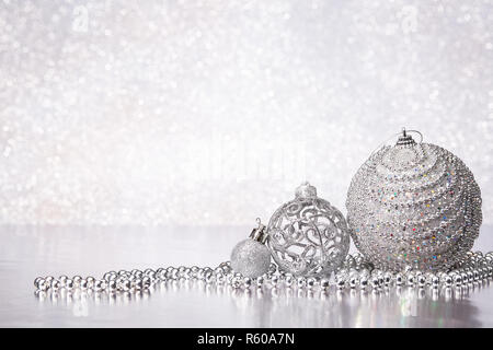 Silvery New Year's ball and decorative snowflake Stock Photo - Alamy