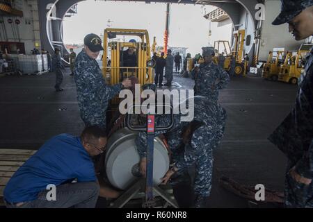(April 27, 2017) Sailors transport supplies down a ladderwell aboard ...