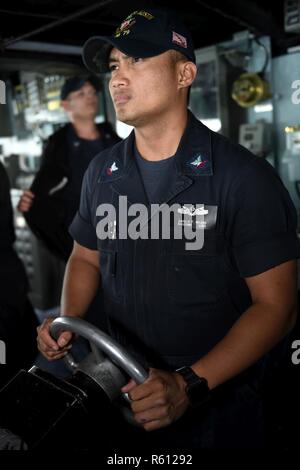 US Navy A Philippine Marine maneuvers through tall grass as he makes ...