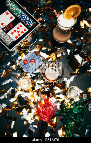 elevated view of playing cards, alcoholic cocktails with orange slices ...