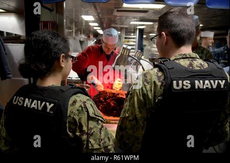 SASEBO, Japan (Nov. 22, 2018) - Capt. Colby Howard (center), commanding ...
