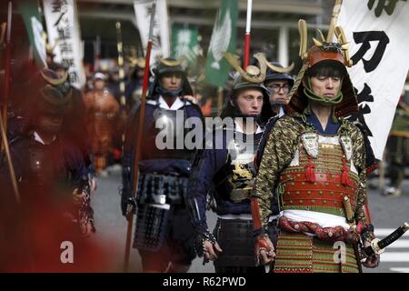 Japanese locals dressed as samurai march down the street during the ...