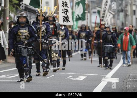 Japanese locals dressed as samurai march down the street during the ...