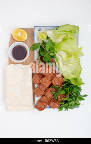 Traditional food cig kofte is on isolated white background. One piece ...