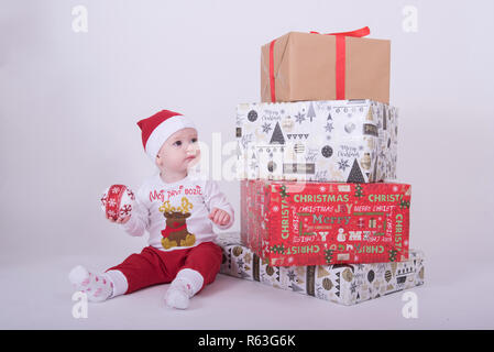 santa helper baby with christmas gifts over white Stock Photo - Alamy
