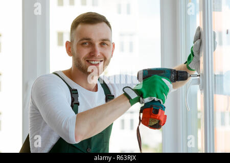 Worker with screwdriver installing window handle indoors Stock Photo ...