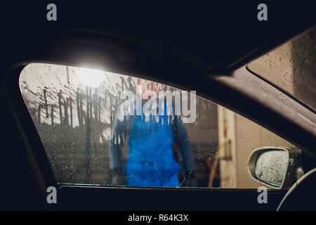 Window washer viewed from the inside of an office building, New ...