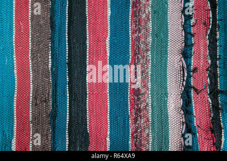 Texture of multi-colored homespun rug. Traditional rustic carpet with a ...