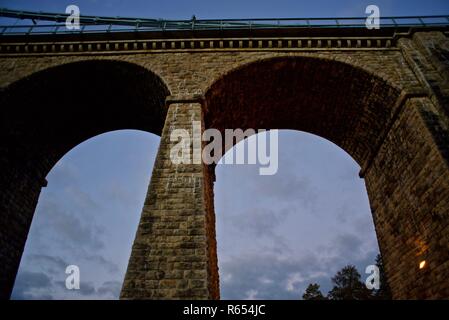 Limestone columns and arches of the Menai Suspension Bridge at dawn ...