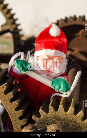 Santa in the cogwheels of consumerism, a concept Stock Photo - Alamy