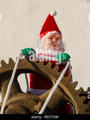 Santa in the cogwheels of consumerism, a concept Stock Photo - Alamy
