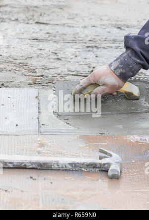 Worker tile mason spreading adhesive on tile for tiling wall Stock ...