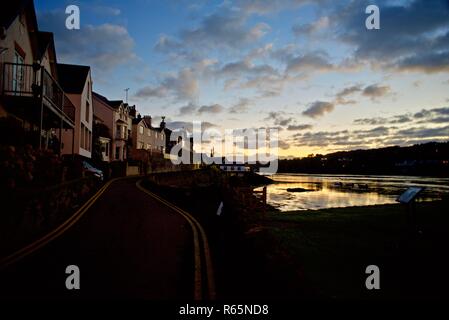 House on the banks of the Menai Strait with Menai suspension bridge in ...