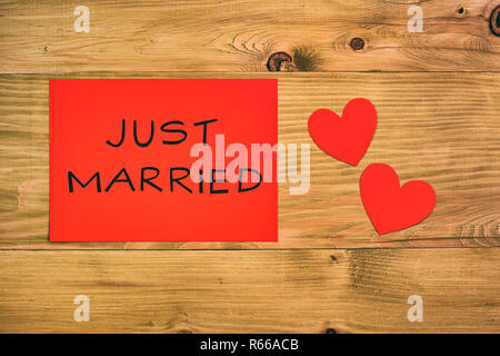 Text just married on the red paper on wooden table Stock Photo - Alamy