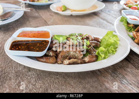 Pig's intestines grilled thai style food Stock Photo - Alamy
