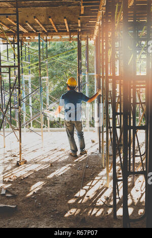 Engineer and Architect working at Construction Site with blueprint ...