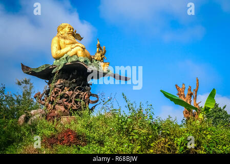 Golden fat deity sculpture Stock Photo - Alamy