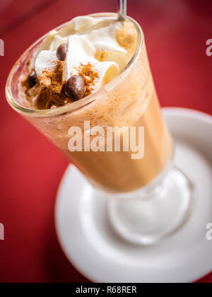 Latte macchiato with whipped cream, serving silver spoon Stock Photo ...