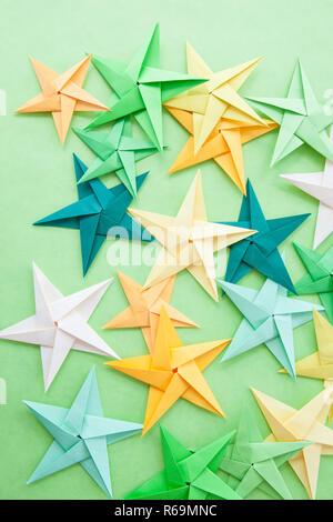 colorful of paper fold christmas stars spilling out from the paper box ...