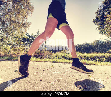 Sweaty man running on rural road. Hispanic male athlete training and ...