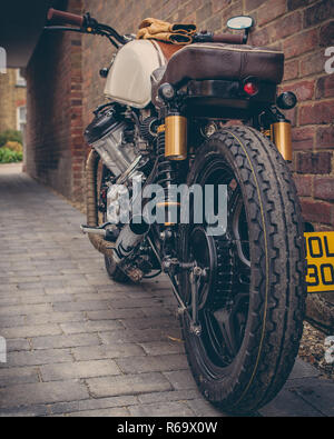 Classic motorbike custom to cafe racer parked in the street. Suzuki ...