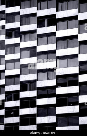 Zig zag shapes of glass windows in modern building wall. Blurry ...