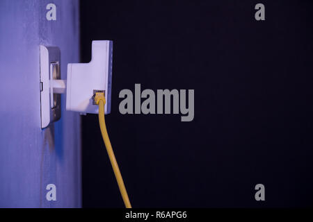 Ethernet cable connected to socket in wall. Internet connection Stock ...