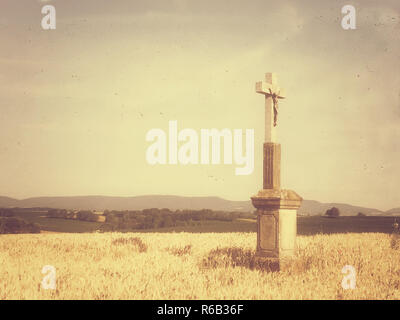 Cross in cornfield in retro style Stock Photo - Alamy