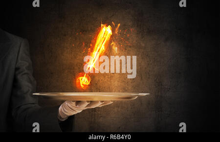 Waitress's hand keeping flaming exclamation mark Stock Photo - Alamy