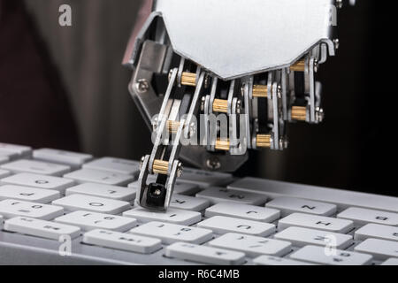 Robot typing on a computer keyboard - automation and AI research Stock ...