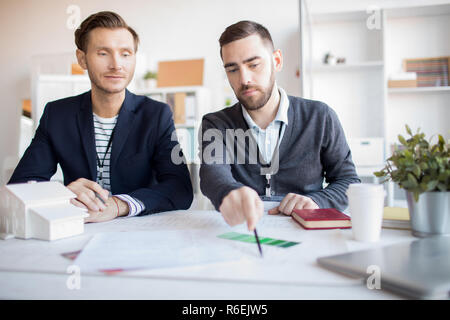Real estate agent with trainee and client in office Stock Photo - Alamy