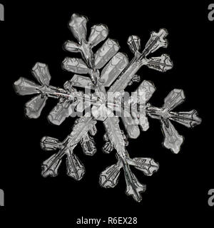 Extreme magnification - Real snowflake isolated on black background ...