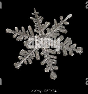 Extreme magnification - Real snowflake isolated on black background ...