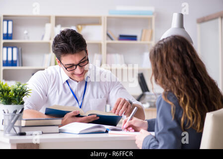 Sales assistant discussing transaction with customer Stock Photo - Alamy