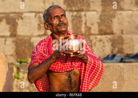 Brahmin meditating at the holy river Ganges in the morning Stock Photo ...