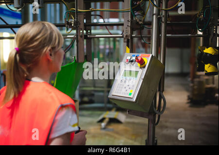 Female manager supervises production in a metal manufacturing plant ...