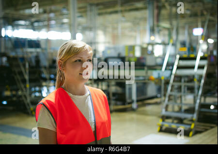 Female manager supervises production in a metal manufacturing plant ...