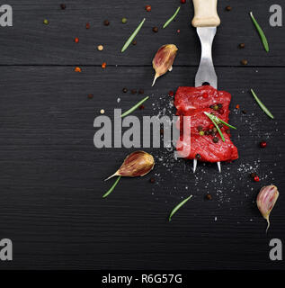 pieces of beef strung on a kitchen fork Stock Photo - Alamy