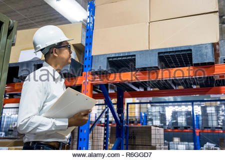Manager in a factory checking a product from production line. Factory ...