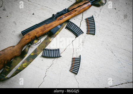 Rifle with cartridges on a textured concrete slab Stock Photo - Alamy