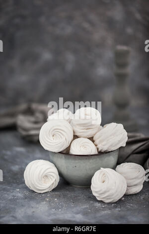 Homemade zephyr or marshmallows in a box on a pink background, Top view ...