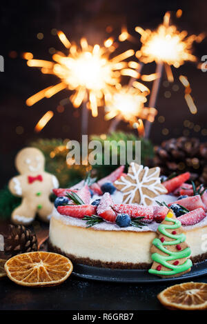 A portion of orange cheesecake with a strawberry decoration served in a ...