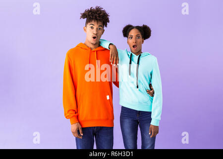 Photo of excited african american couple wearing colorful sweatshirts ...