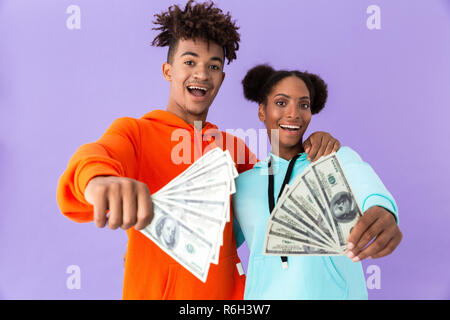 Photo of lucky excited brother sister wear xmas sweaters rising fists ...