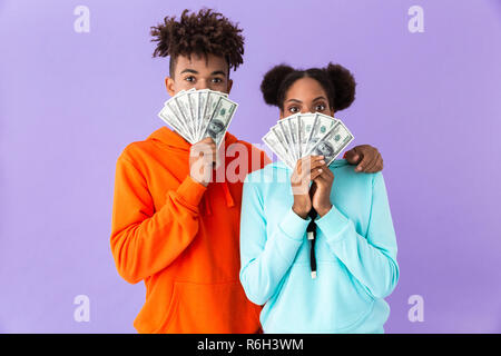 Photo of lucky excited brother sister wear xmas sweaters rising fists ...